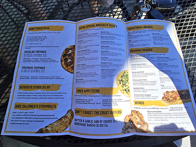 A menu that reads like a love letter to both pizza traditionalists and culinary adventurers. The Reuben pizza isn't just listed—it's beckoning.