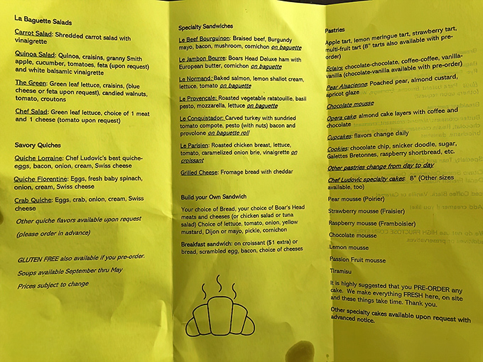 The yellow menu reads like poetry for the hungry. Each line represents not just food, but a potential life-changing experience wrapped in butter and flour.