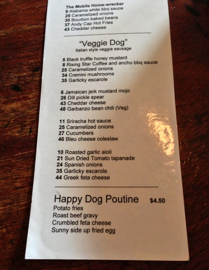 The menu reads like a mad scientist's experiment log, if that scientist were obsessed with creating the perfect hot dog. Black truffle honey mustard? Absolutely.