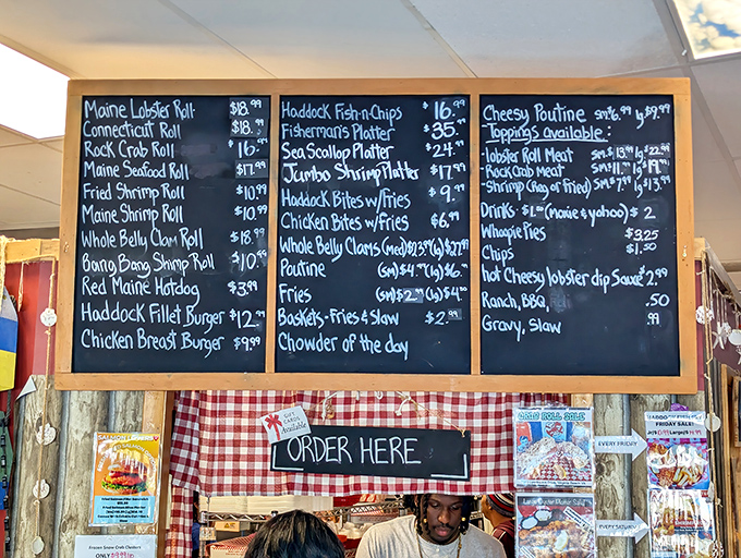 The chalkboard menu reads like a love letter to New England seafood traditions, with lobster rolls taking center stage.