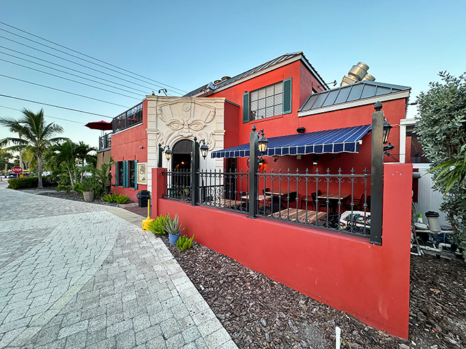 This vibrant red restaurant isn't just a building&mdash;it's a love letter to color in a world of beige vacation rentals. The blue awnings practically whisper "come sit outside."