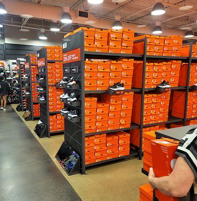 The iconic orange boxes stacked like a monument to athletic achievement. Nike's temple of discounted swooshes makes sneakerheads weak in the knees.