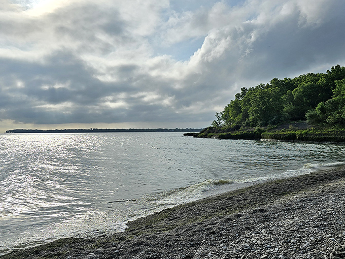 Mother Nature's mood swings create dramatic skyscapes over Lake Erie's shoreline, where clouds and sunlight battle for attention in this ever-changing watercolor.