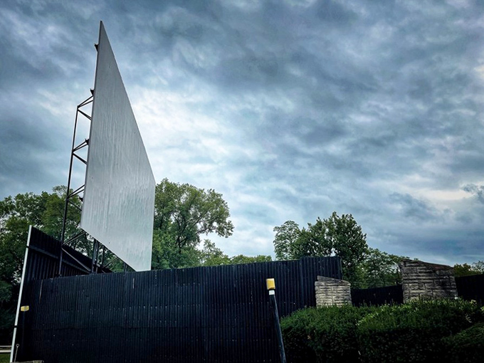 Against moody skies, this towering screen waits silently for dusk, when stories will dance across its blank canvas.