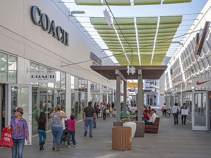Shoppers stroll beneath cleverly designed canopies that say, "Yes, we know it's the desert, and no, we won't let you melt while hunting for deals."