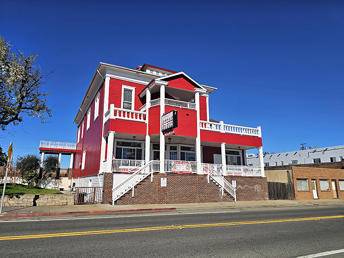 The vibrant red Peter's Steakhouse stands as a cheerful landmark against Isleton's blue skies, promising hearty meals without big-city prices.