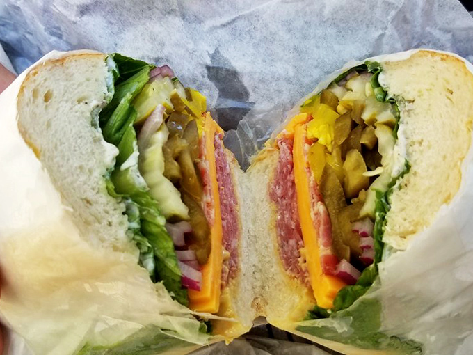 Behold sandwich architecture at its finest! Layers of meat, cheese, and fresh veggies create a cross-section worthy of a food museum exhibit.