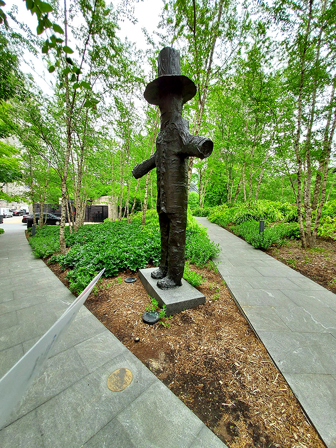 Not your average scarecrow! This contemplative bronze figure stands sentinel among the birch trees, a quiet observer of city life.