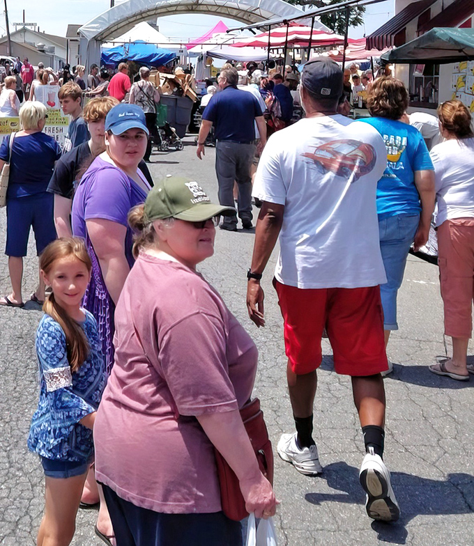 A sea of shoppers navigates the market's maze-like pathways. The thrill of discovery keeps everyone moving forward.