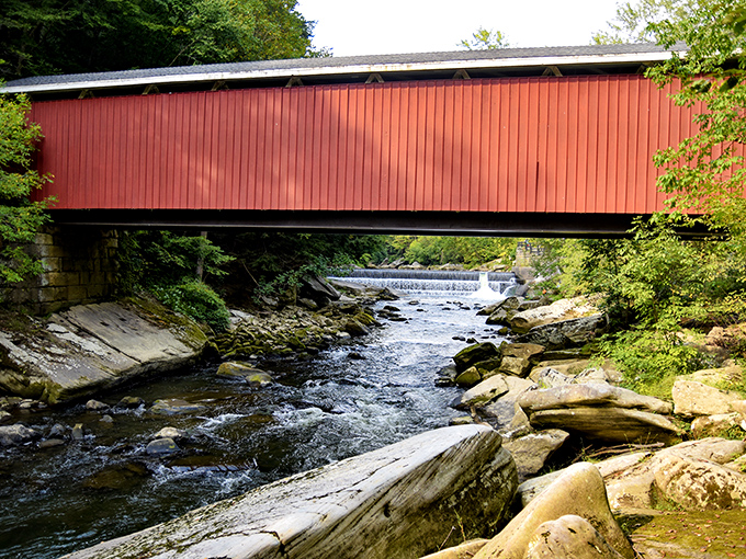 Nature frames this masterpiece of 19th-century engineering, where rushing waters and weathered stone foundations have supported travelers for nearly 150 years.