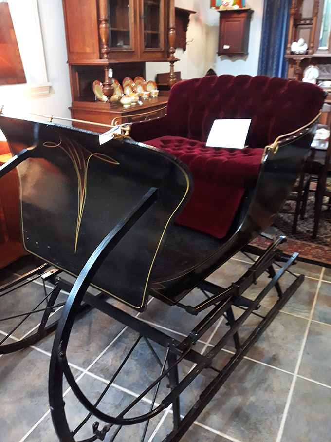 This vintage sleigh with plush burgundy upholstery isn't just transportation&mdash;it's a time machine to winters past. Dash away, dash away, dash away all!