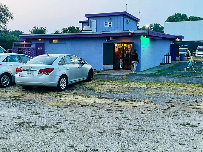 The purple gateway to nostalgia stands guard at the entrance. This vibrant ticket booth has welcomed film lovers through decades of blockbusters and cult classics.