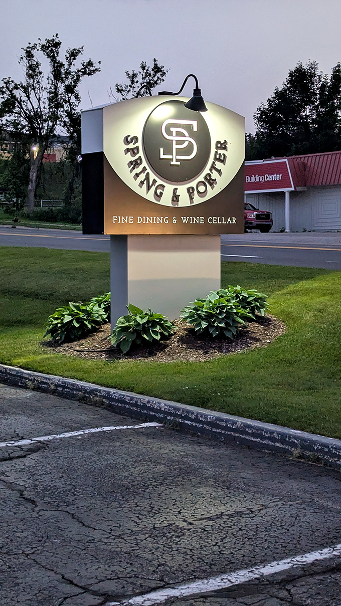 Fine dining at Petoskey's Spring & Porter restaurant, where the illuminated sign promises an evening worth dressing up for.