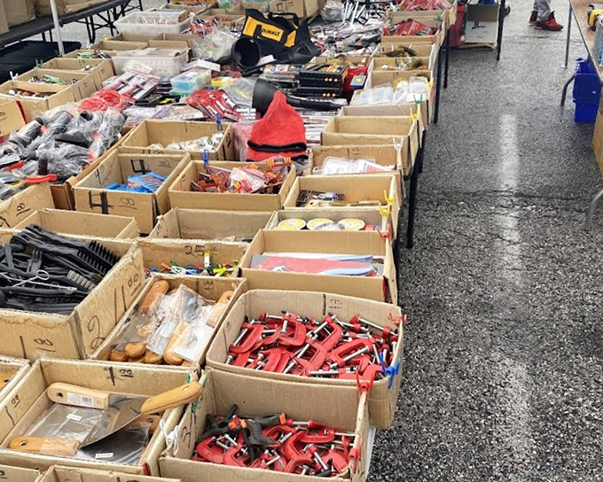 A shopper's paradise unfolds under industrial ceilings, where guitars hang like ripening fruit next to racks of clothing and tables overflowing with everyday essentials.