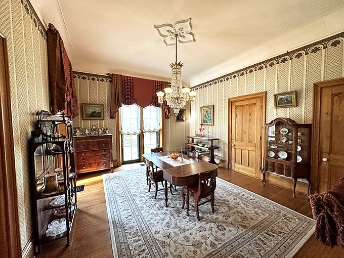 The dining room's crystal chandelier and patterned wallpaper whisper stories of elaborate Victorian dinners where gossip was served alongside every course.