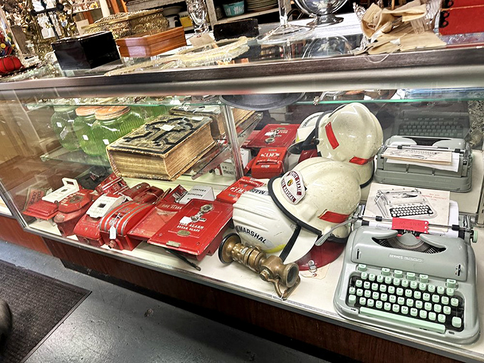 Typewriters, vintage caps, and forgotten gadgets await new homes. This display case is basically a time capsule with price tags.