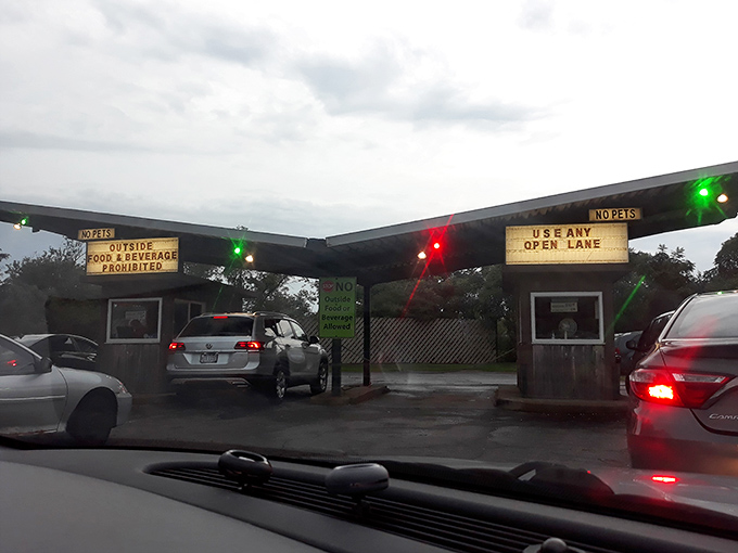 "Outside food prohibited" reads the sign, but the real prohibition would be missing the authentic drive-in experience these entrance booths have guarded for decades.