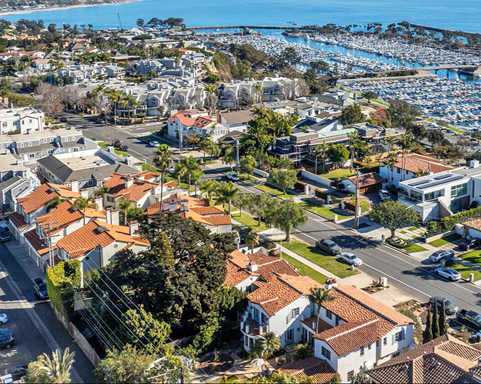 Dana Point's residential streets cascade toward the Pacific, where terracotta rooftops create a distinctly California palette against the endless blue horizon.