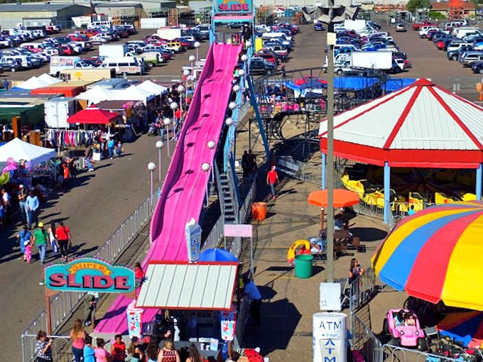 The famous pink Super Slide towers over a sea of vendors and vehicles. It's like Disneyland for deal-seekers, minus the $20 churros.