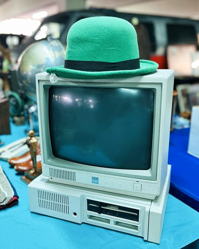 "I'm ready for my close-up, Mr. DeMille!" An old IBM computer dons a jaunty green derby, proving even obsolete technology deserves a second act.