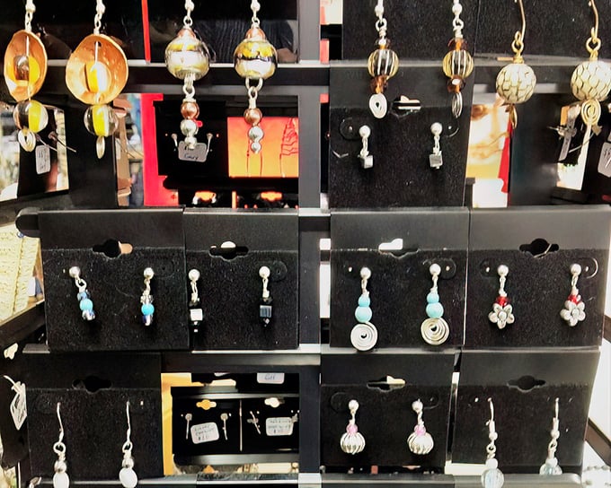 Handcrafted earrings catch the light and imagination &ndash; each pair waiting to become someone's perfect conversation starter.