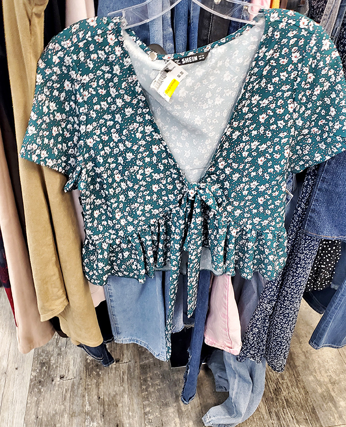 This floral top whispers "spring picnic" or "coffee date confidence" while the yellow tag screams "cheaper than your morning latte."
