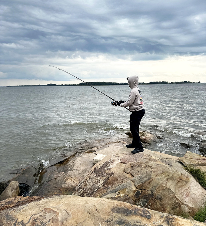 Patience wears a hoodie at Rocky Point. This angler knows the best conversations happen between casts, with water providing the background music.