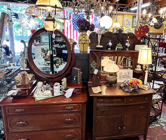 Vintage furniture arranged like a time-traveling living room. That dresser with the oval mirror has probably witnessed a century of "How do I look?" moments.