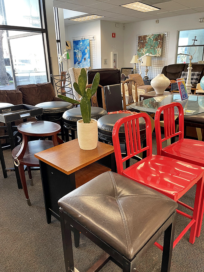 Red chairs pop against neutral furniture pieces &ndash; proof that secondhand shopping can yield design-magazine-worthy finds without the design-magazine prices.