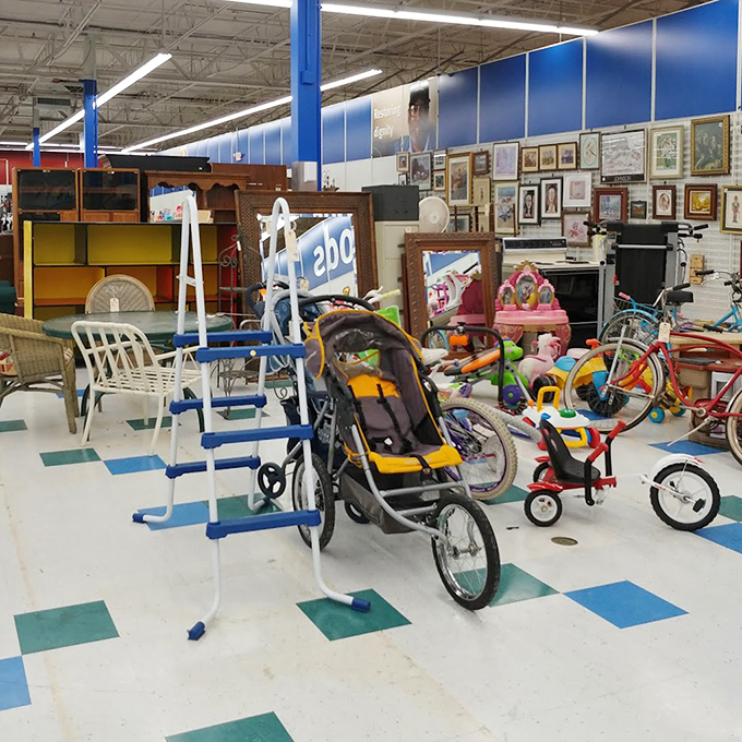 A playground for the practical dreamer. Strollers, bikes, and furniture await new homes in this corner where one family's outgrown items become another's perfect find.