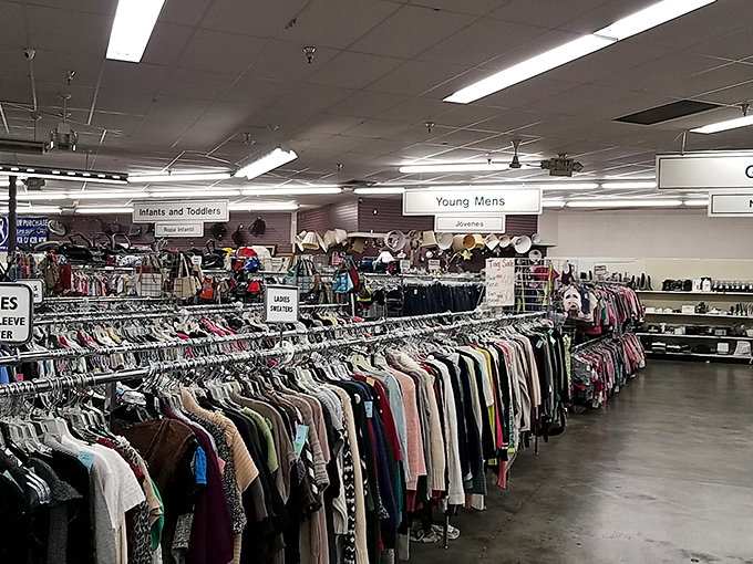 Racks stretch endlessly like a fabric rainbow, each hanger holding someone's forgotten fashion statement.