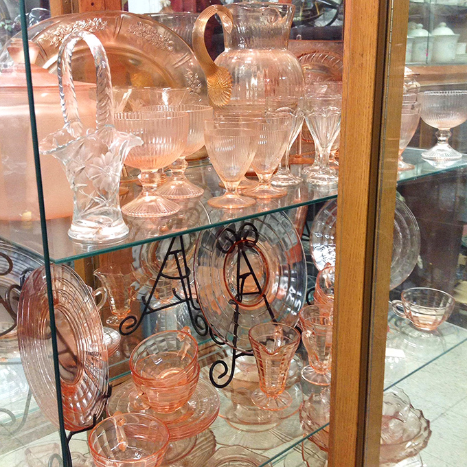 Depression-era pink glassware catches the light, each delicate piece whispering tales of elegant dinner parties from generations past.