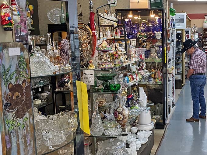 Crystal and glassware catch the light like an underwater cave of treasures, each shelf a testament to entertaining styles of decades past.