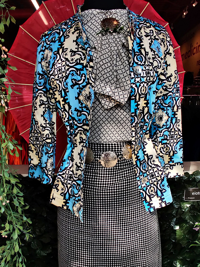 This blue patterned blazer isn't just clothing&mdash;it's a conversation starter waiting to happen. Paired with that checkered skirt? Pure thrifting magic.