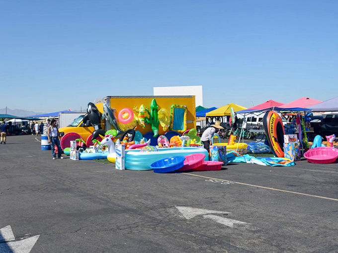 Summer essentials abound! Inflatable pools, floaties, and water toys create a mirage of backyard fun, even in the middle of the desert.