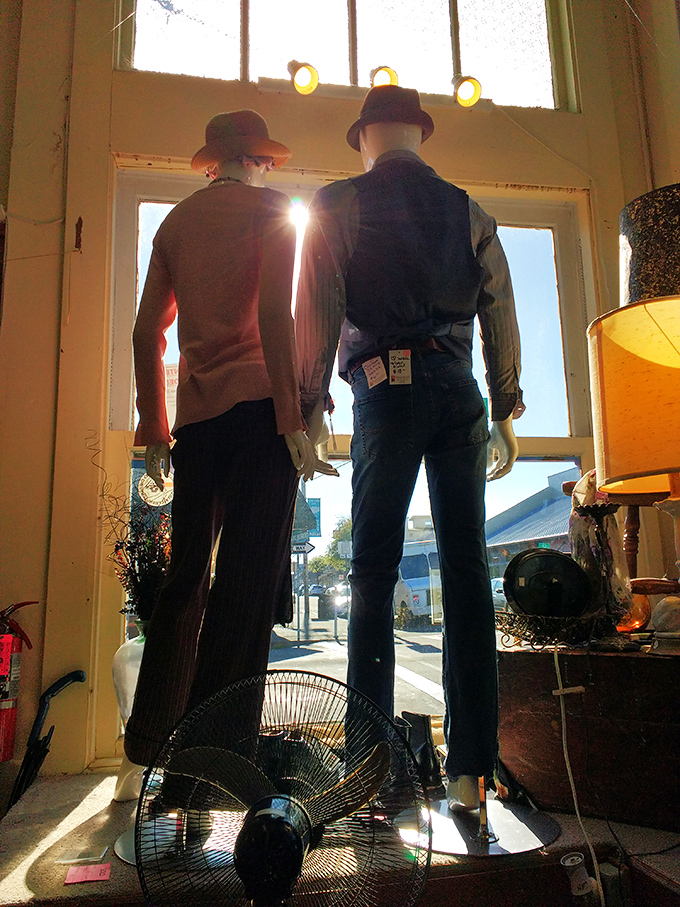 These dapper mannequins guard the entrance like silent sentinels of style, offering fashion inspiration from decades past.