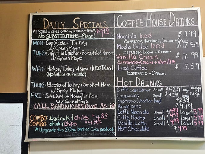 The chalkboard menu – a daily scripture of sandwich salvation that changes with the rhythms of the week.