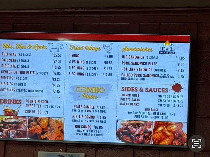 The menu board at E&L is like a treasure map where X marks the spot for smoked meat nirvana. Those prices? A bargain for edible art.