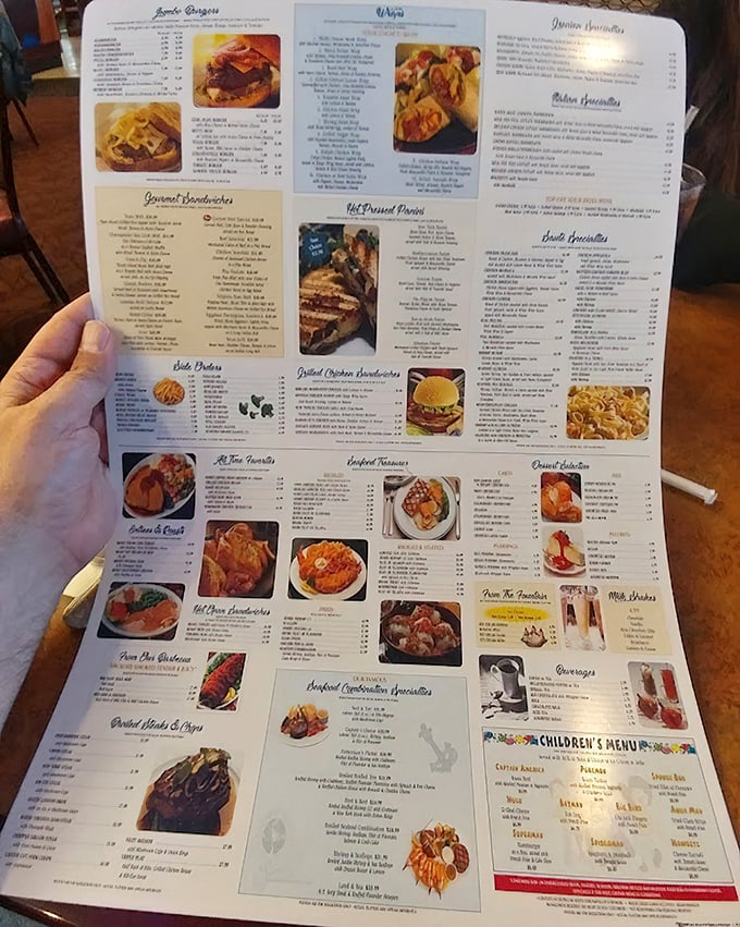 The menu unfolds like the Sunday paper, a glorious roadmap to comfort food paradise where decisions become deliciously difficult.