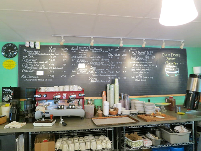 The chalkboard menu promises caffeinated salvation alongside your pastry pilgrimage. Coffee and croissants: civilization's greatest pairing since Lennon and McCartney.