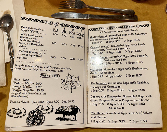 The handwritten menu at Al's reads like a breakfast love letter. Each quirky name hints at decades of regular customers immortalized in egg form.