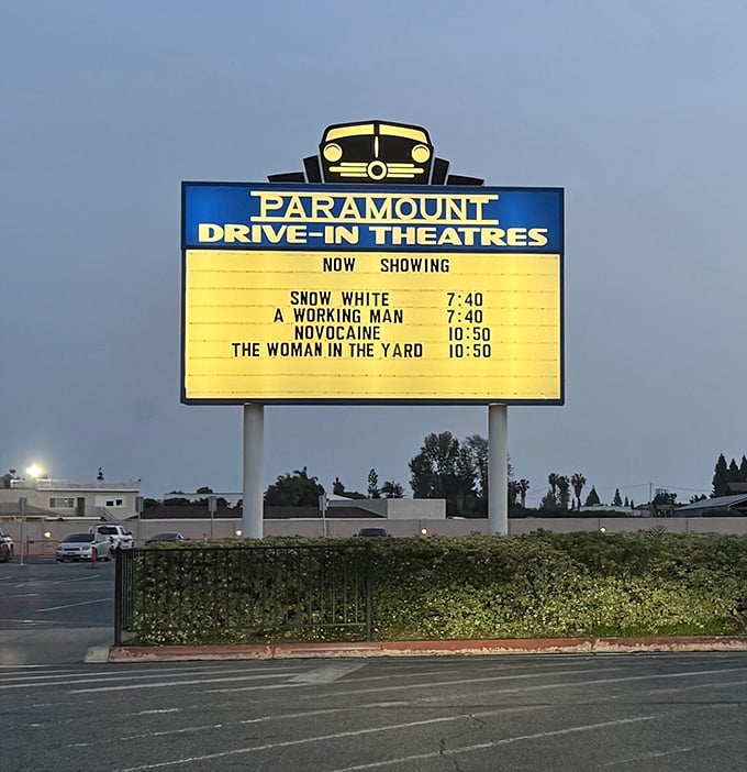 The iconic blue and yellow marquee, a beacon of cinematic promise standing tall against the darkening California sky.