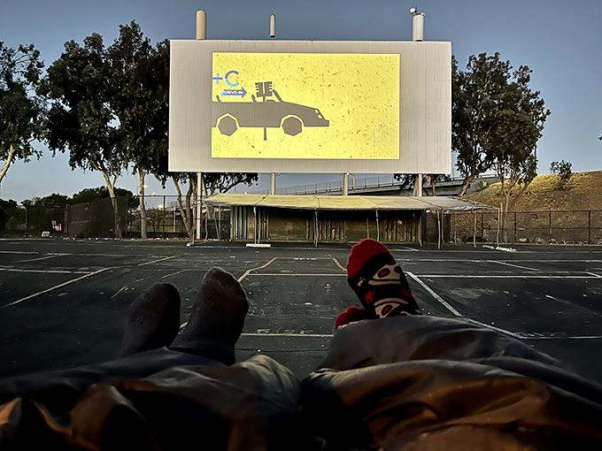 The ultimate comfort zone: sock-clad feet propped up, cozy blanket, and a movie projected on a massive screen under open California skies.