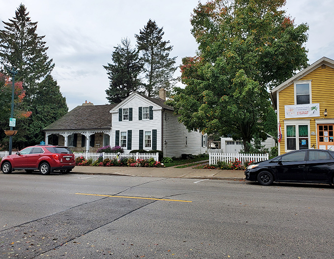 This charming white cottage with its perfect picket fence isn't a movie set&mdash;it's someone's actual home, making you wonder if you should check local real estate listings.