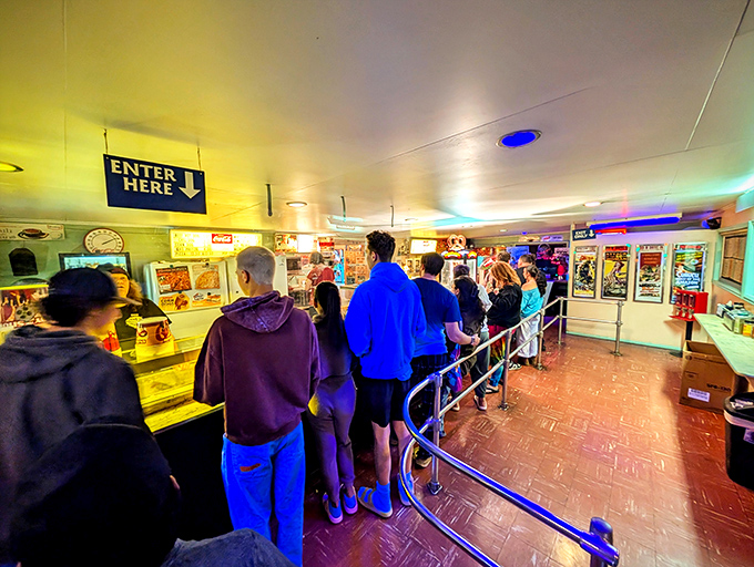 The concession line shuffle&mdash;a time-honored intermission ritual where strangers become temporary friends united by the quest for buttered popcorn.