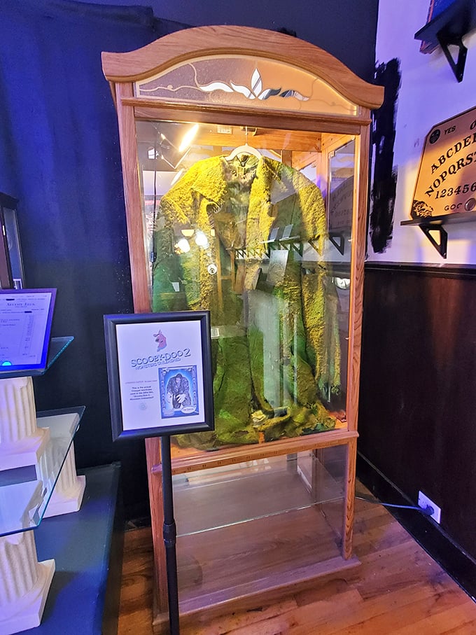 This eerie display case houses what appears to be a ceremonial robe, with a Ouija board visible nearby&mdash;communication with the beyond, anyone?