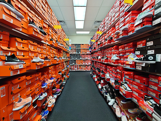 Sneaker heaven stretches before you like the retail promised land. Orange and red boxes stacked with possibilities and athletic aspirations.