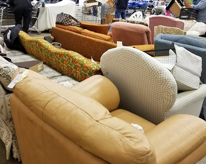 A sea of sofas awaits new homes. That floral pattern couch? Pure 1970s nostalgia that's somehow circled back to trendy again.