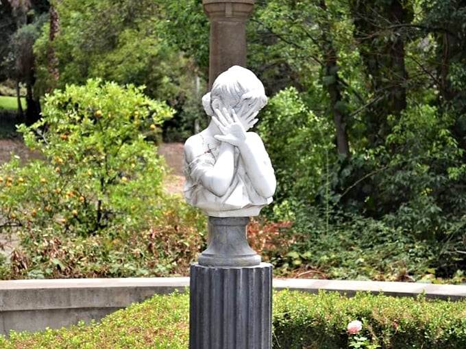 Even stone children need privacy sometimes! This whimsical statue brings unexpected personality to the gardens, hands covering face in eternal peek-a-boo.
