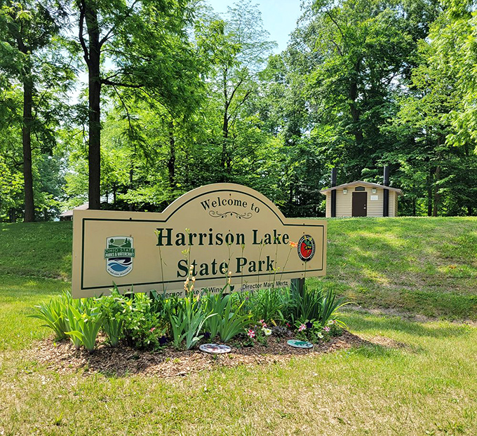 The park entrance sign stands sentinel among spring greenery, like nature's version of a "You've arrived!" text message.